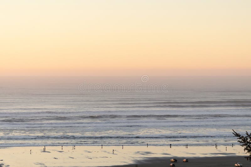 People Watching the Sunset Along the Beach Stock Photo - Image of beach ...