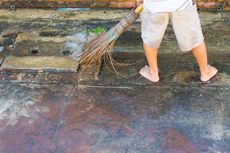 People Who are Using a Broom To Sweep the Floor Clean Stock Photo ...