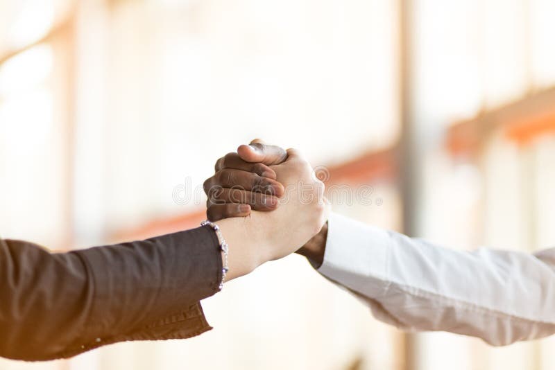 People at Work: Man and Woman Hand Shaking at a Meeting Stock Photo ...