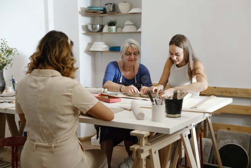 Group of People at Pottery Workshop in Cozy Studio Working with Clay ...