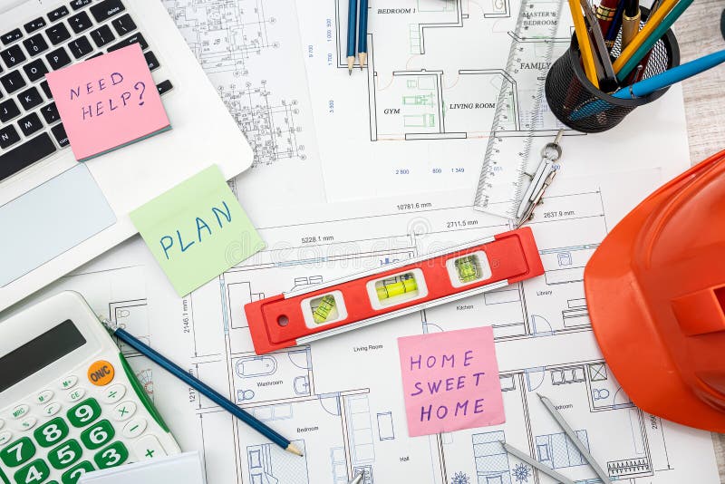 People Working with Construction Drawings and Tools at a Wooden Table ...