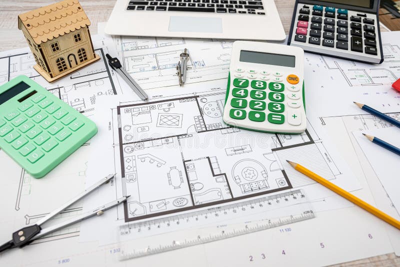 People Working with Construction Drawings and Tools at a Wooden Table ...