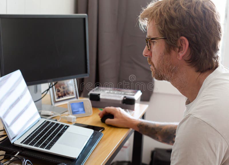 Serious Man Working at Home on His Computer Stock Image - Image of ...