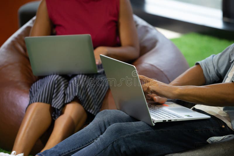 People Working with Laptop Computers on Sofa Stock Image - Image of ...