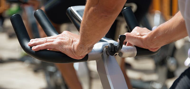 People Working Out on Exercise Stationary Bicycle Stock Photo - Image ...
