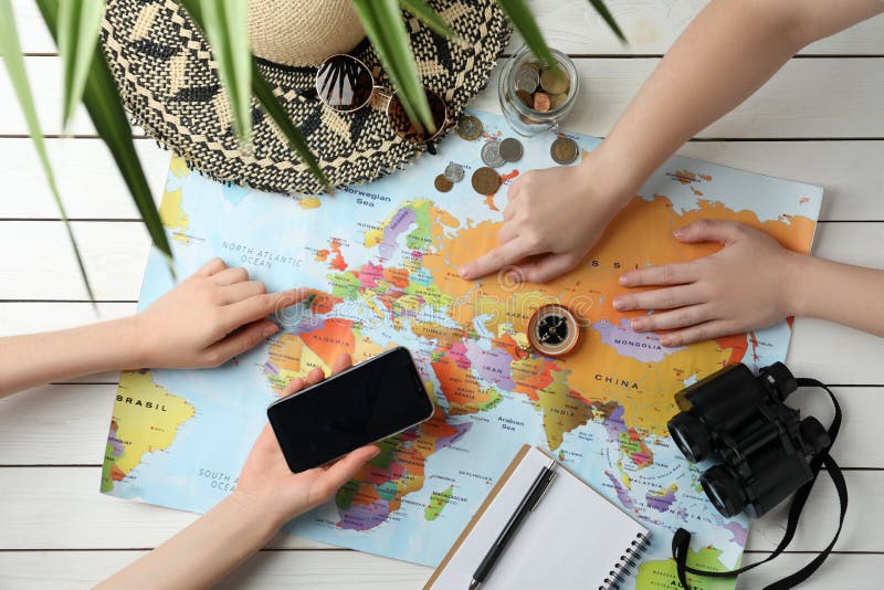 People with World Map and Accessories at Table. Travel during Summer ...
