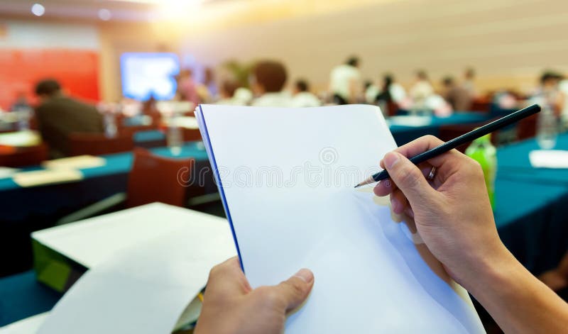 People Writing on Document at Business Seminar Stock Image - Image of ...
