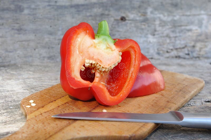 Pepper Cut in Half on a Plank Stock Image - Image of ingredient ...