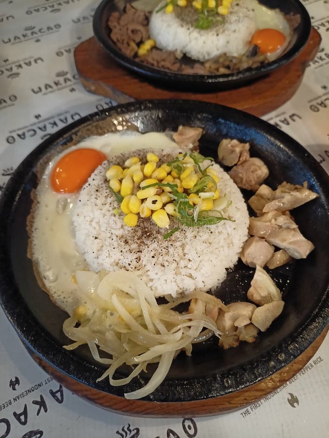 Pepper Rice with Chicken, Corn, and Egg on a Hotplate Stock Image ...