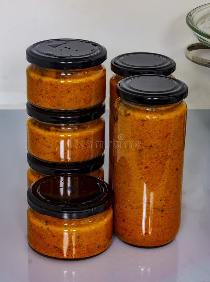 Pepper sauce in glass jars stock image. Image of homemade - 259109819