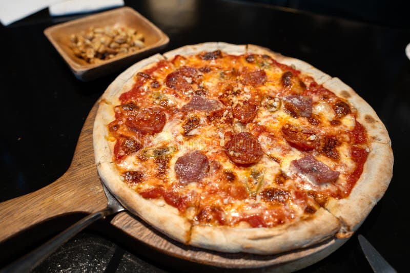 Pepperoni Pizza and Peanuts on a Restaurant Table Stock Image - Image ...