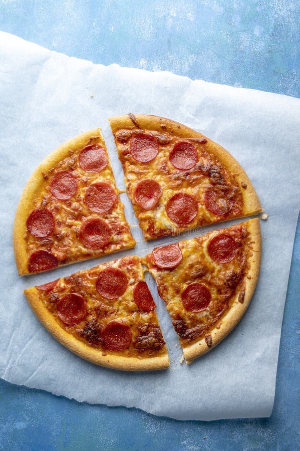 Pepperoni Pizza Sliced, on Blue Background, One Pizza, Top View Stock ...
