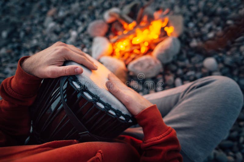 Percussionist Playing Djembe Sitting by Fire, Close-up Stock Image ...