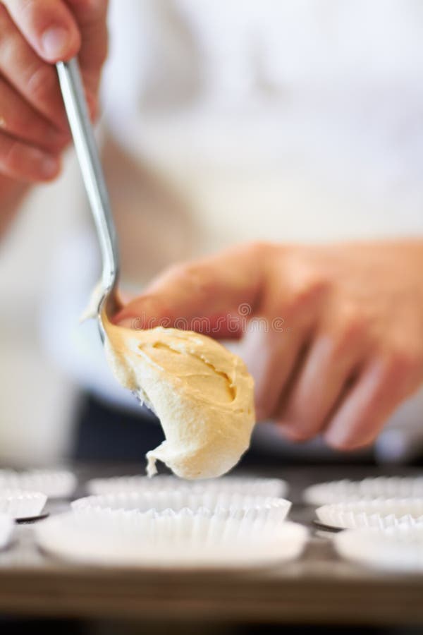 The Perfect Batter. a Close Up of a Baker Pushing Cupcake Batter from a ...
