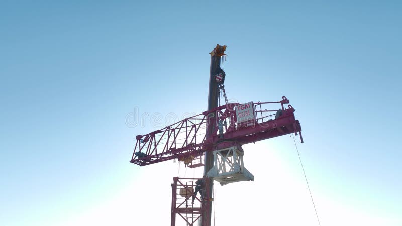 Aerial View: Operator Navigates Ladders Skillfully, Assembling Crane ...