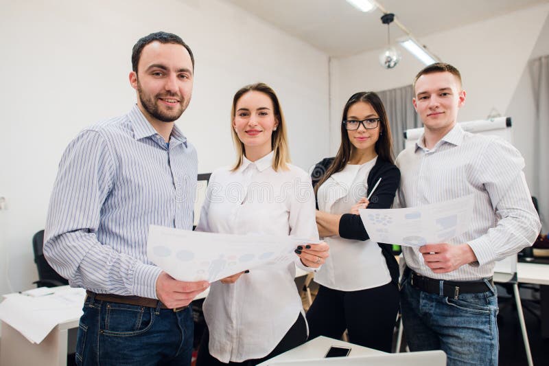 Perfect Creative Team. Group of Four Cheerful Young People Looking at ...