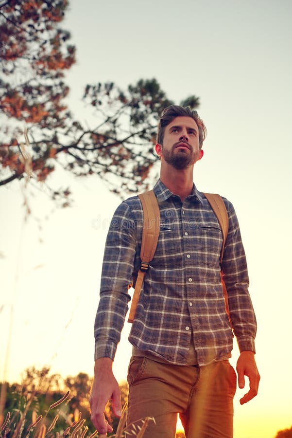 The Perfect Day for a Hike. Shot of a Handsome Young Man Enjoying a ...