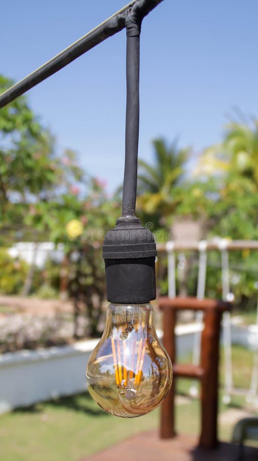 A Perfect Hanging Outdoor Incandescent Light Bulb in Day Light Stock ...