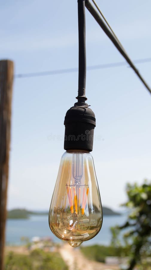 A Perfect Hanging Outdoor Incandescent Light Bulb in Day Light Stock ...