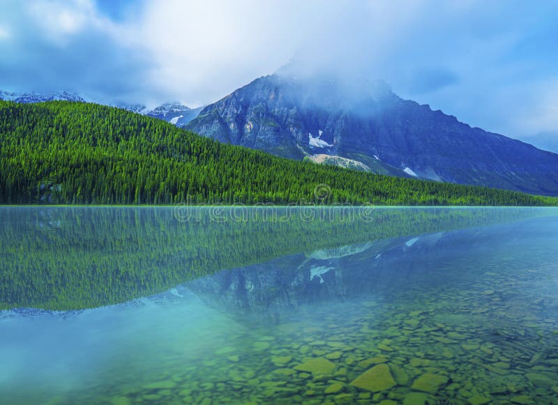 Perfect Mountain Lake Scene with Blue Mountains and Green Forest Stock ...