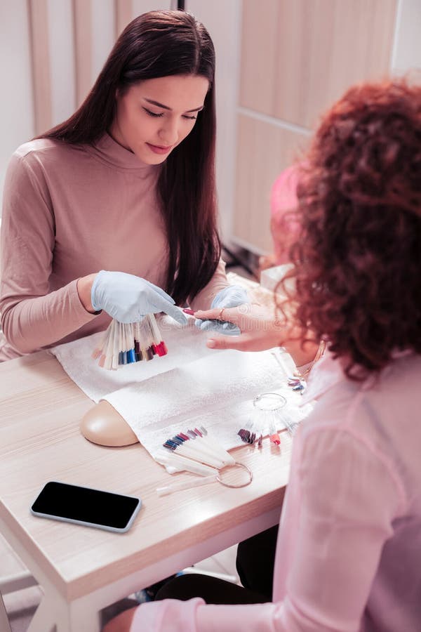 Pleasant Skilled Nail Master Choosing the Colour Stock Image - Image of ...