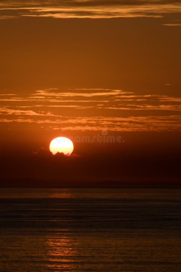 A Half Sun Shows Over Ocean at Sunrise Stock Image - Image of morning ...