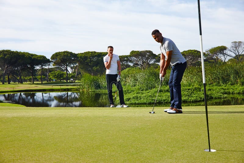 Perfecting His Putt. Two Handsome Men on the Putting Green. Stock Photo ...
