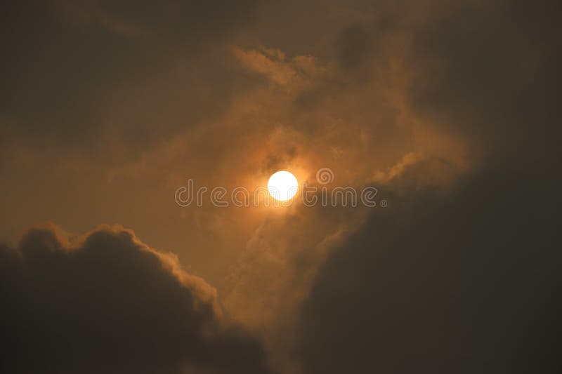 A Perfectly Round Sun Surrounded by Clouds Stock Photo - Image of ...