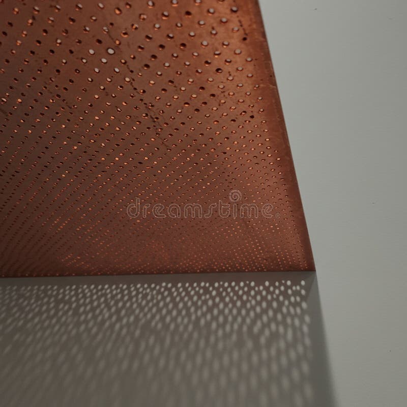 Perforated Sheet with a Rust-brown Tone, Casting a Pattern of Circular ...