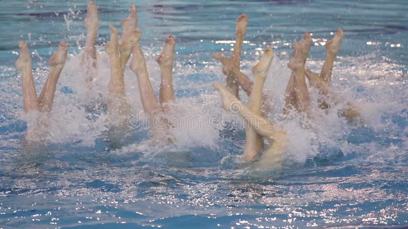 Synchronized Swimmers Start Their Performance Wearing High Heeled Shoes ...