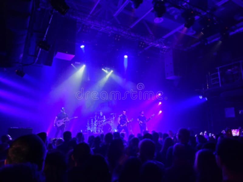 Performance of a Rock Group at a Concert with a Brightly Lit Stage. the ...