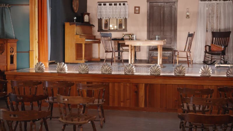 A Performance Stage Equipped with a Piano, Table and Chairs Stock ...