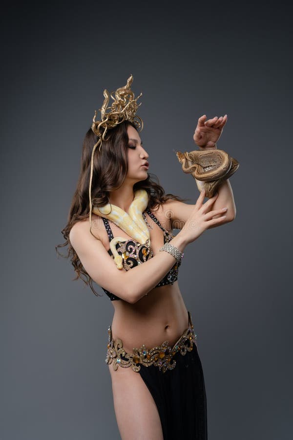Performer Showcases Captivating Dance with Exotic Snake in Studio Setting Stock Image - Image of ...