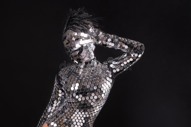 Dancer in a Sparkling Mirror Costume Poses Dramatically Against a Dark ...