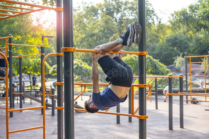 Performing Acrobatic Exercises on the Horizontal Bar. Stock Image ...