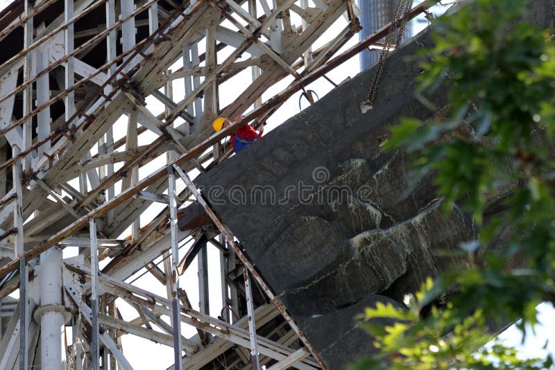 Performing Heavy Construction Work. a Worker Climbs in Height and ...