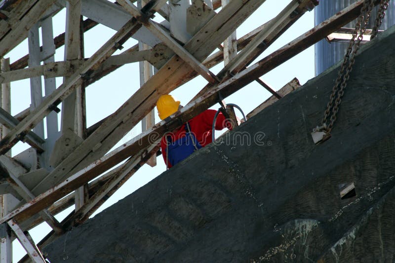 Performing Heavy Construction Work. a Worker Climbs in Height and ...