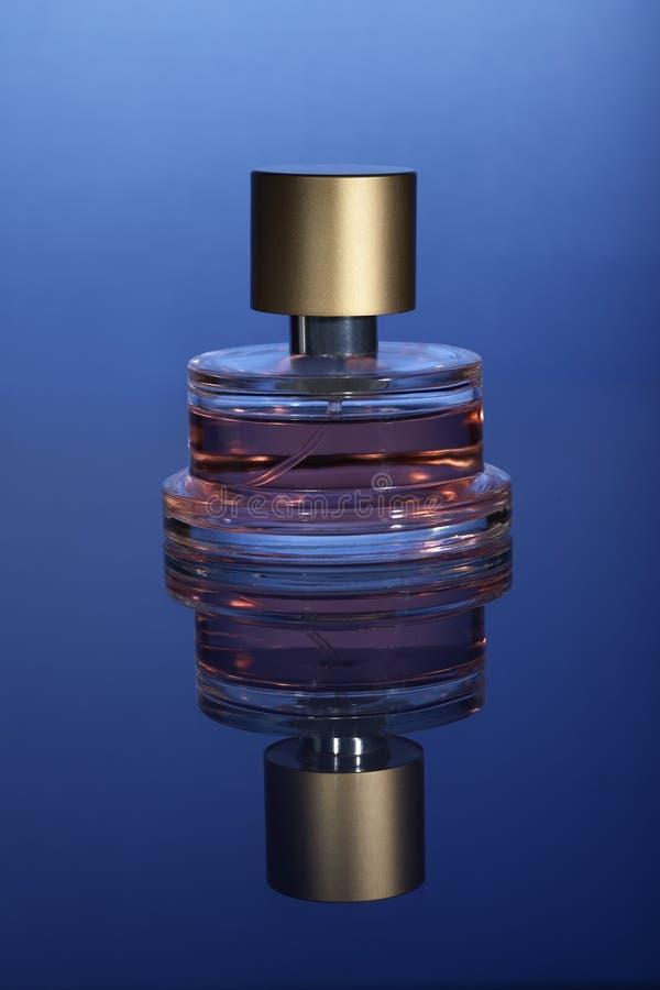 Perfum Bottle with Reflected on Blue Stock Image - Image of liquid ...