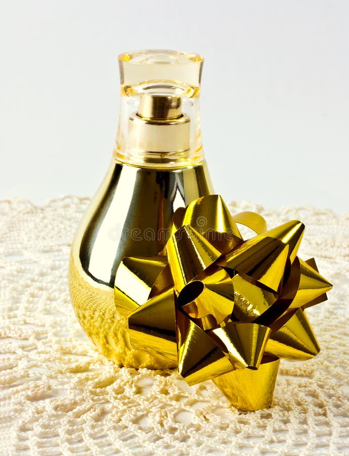 A Golden Bow and Gold Bottle. Stock Image - Image of femininity ...