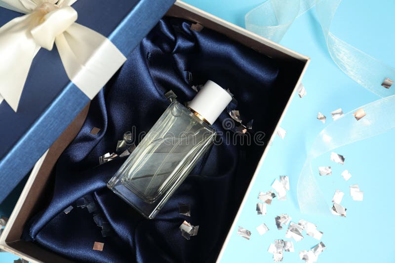 Perfume Bottle in Gift Box and Confetti on Light Blue Background, Top ...