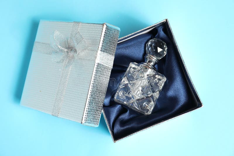 Perfume Bottle in Gift Box on Light Blue Background, Top View Stock ...
