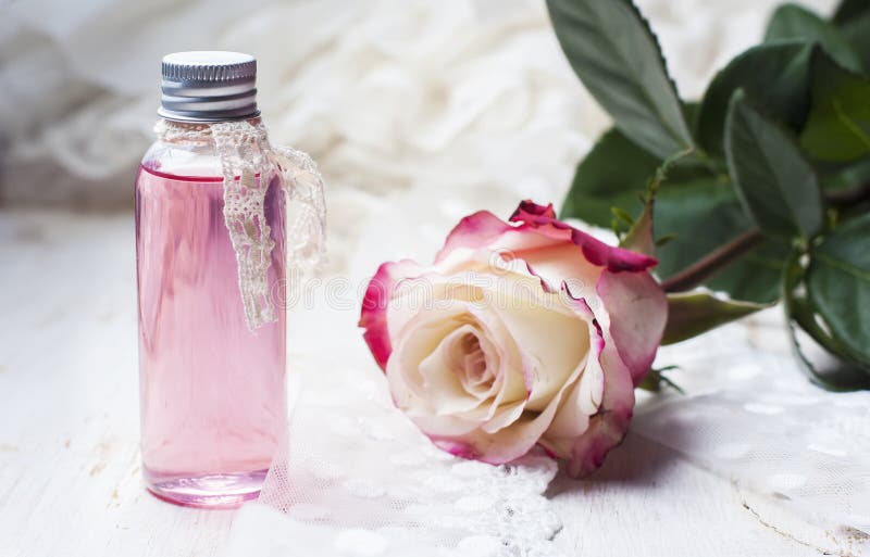 Perfumed Rose Water in a Bottle on a Wooden Table Stock Image - Image ...