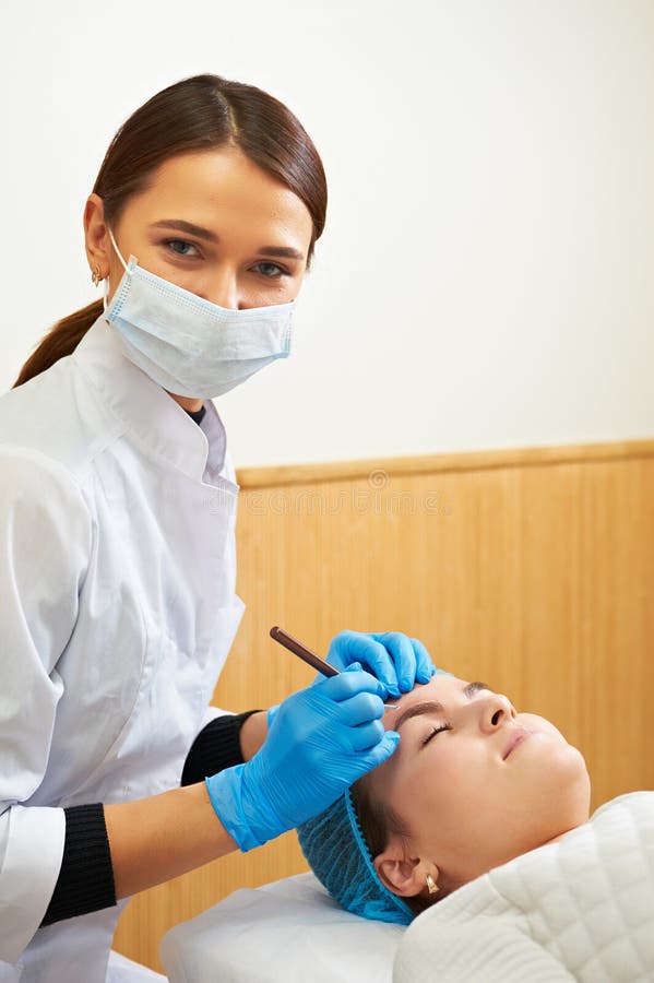 Permanent Make-up Wizard Makes Eyebrow Correction Procedure. Stock ...