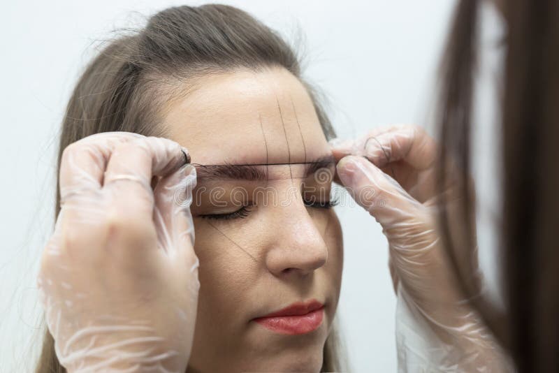 Permanent Makeup, Eyebrow Tattoo. the Master Draws Lines with a Thread ...