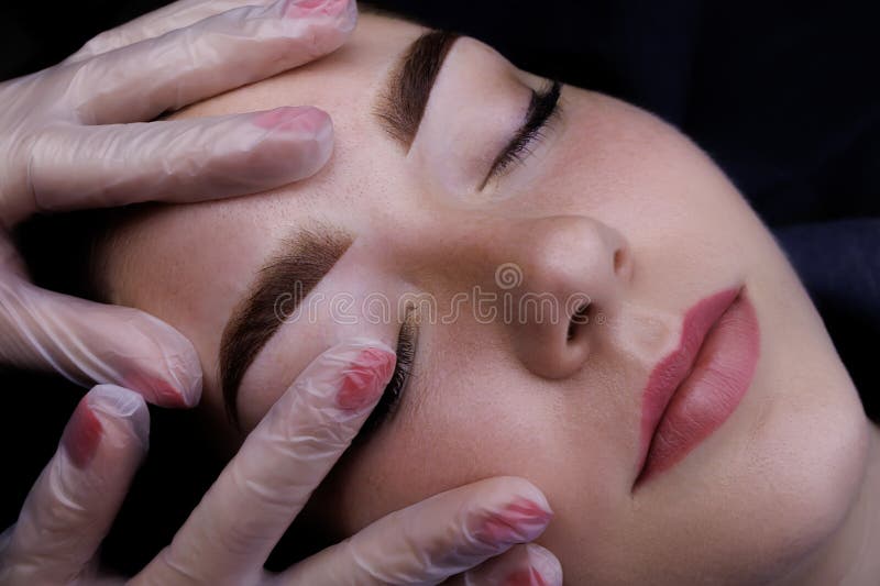 Permanent Makeup of the Eyebrows, the Master Touches the Eyebrows of ...