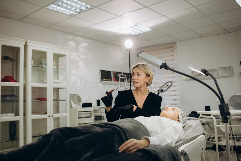 Permanent Makeup on Eyebrows by Professional Cosmetologist. Stock Photo ...