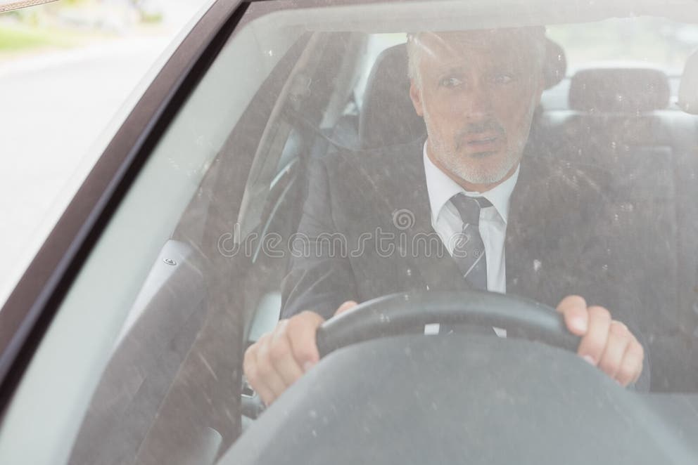 Perplexed Man Sitting at the Wheel Stock Image - Image of mature ...