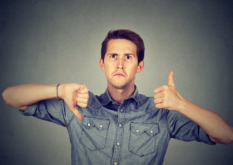 Perplexed Man with Thumbs Down Thumbs Up Gesture Stock Image - Image of ...