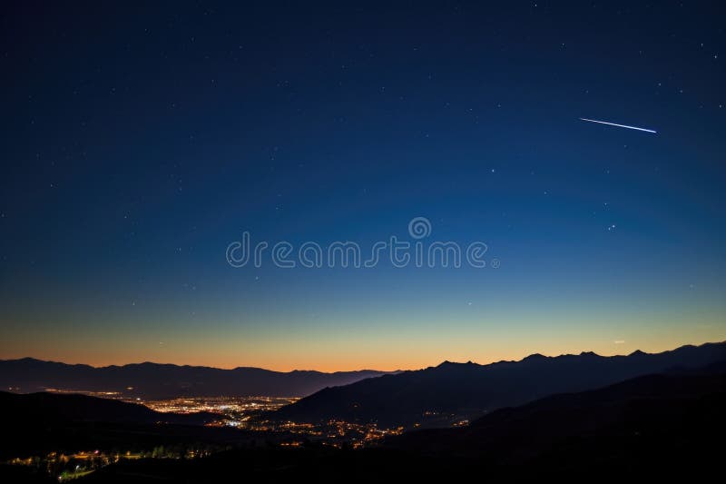 Perseid Meteor Shower Over a Silhouetted Mountain Range Stock Image ...