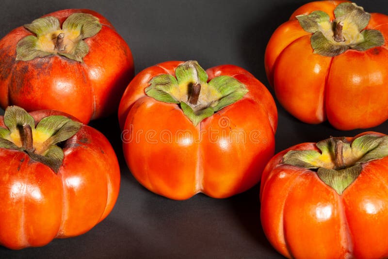 Persimmon group on black stock image. Image of orange - 247069337